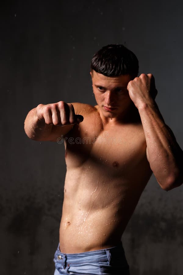 Athlete Bodybuilder Trains in the Studio in the Rain. Stock Photo ...