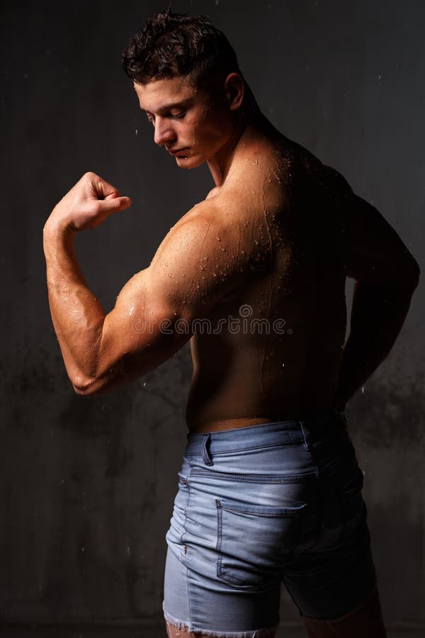 Athlete Bodybuilder Trains in the Studio in the Rain. Stock Photo ...