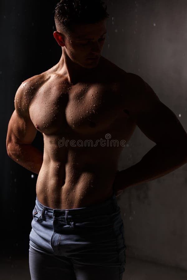 Athlete Bodybuilder Trains in the Studio in the Rain. Stock Photo ...