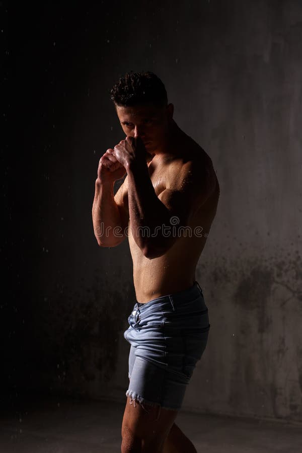 Athlete Bodybuilder Trains in the Studio in the Rain. Stock Photo ...