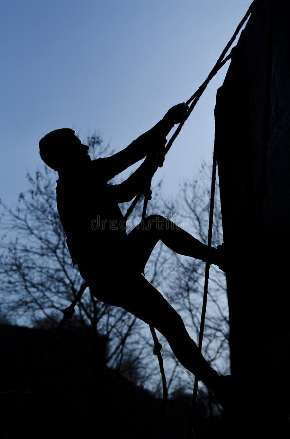 Athlete Climbing an Obstacle Using a Rope in a OCR Race Stock Image ...