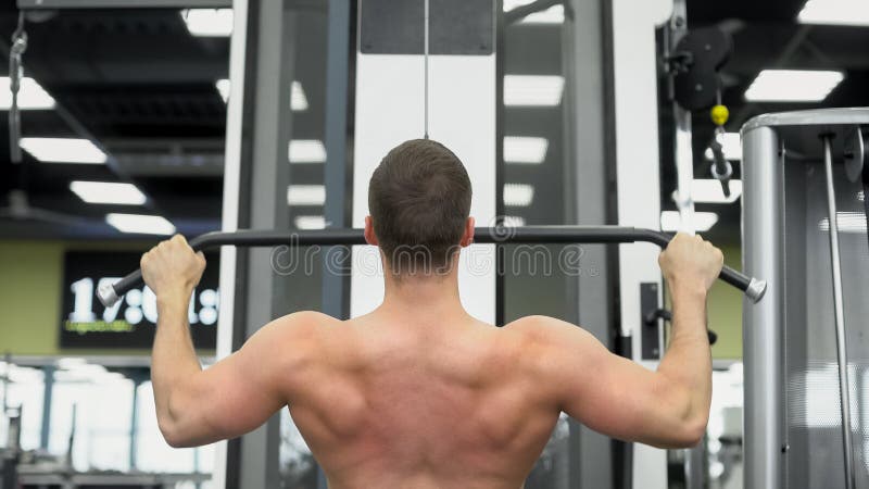 The Athlete Does Exercises for the Muscles of the Back. Muscular Back ...