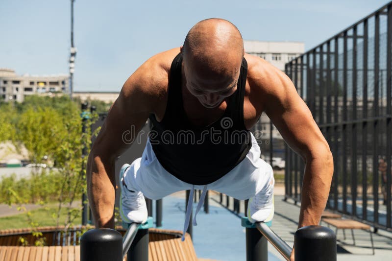 Athlete Does Plank and Push Ups on Sport Ground. Outdoors Training ...