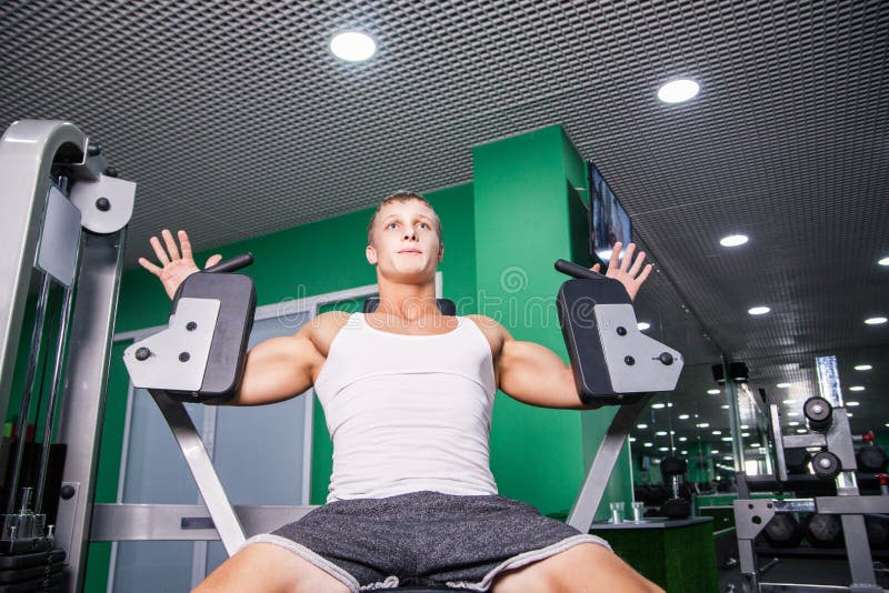 Young Man Doing Chest Exercise with Cable Ropes Stock Photo - Image of ...
