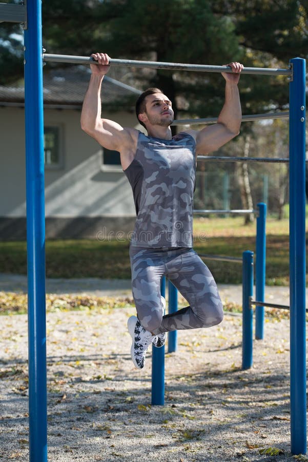 Athlete Doing Exercise with Dips Bar in Park Stock Image - Image of ...