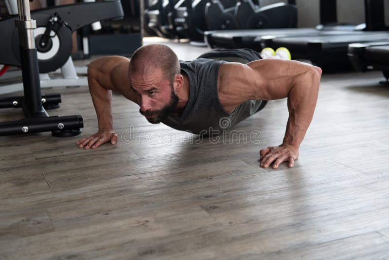 Man Doing Press Ups in Gym stock photo. Image of person - 183032450