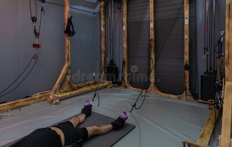 Athlete Doing Rehabilitation Exercises Using Cable Pulley Machine Stock ...