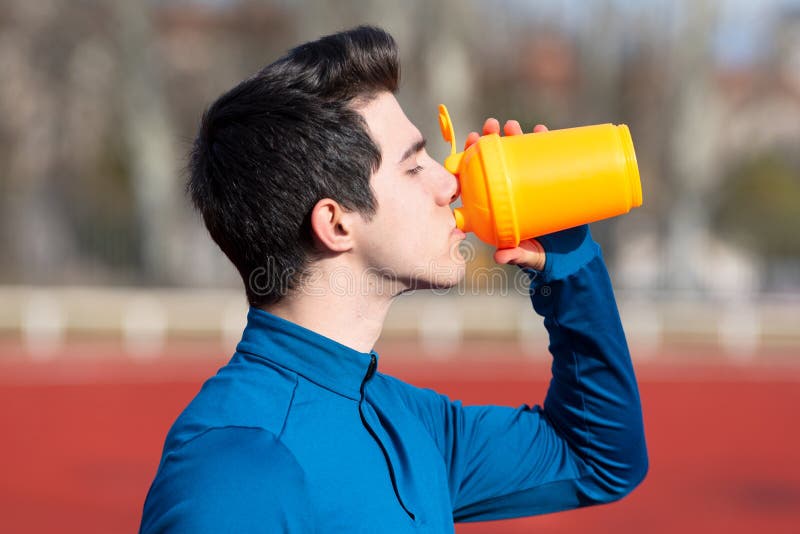 Athlete Drinking Water on a Running Track. Stock Photo - Image of ...