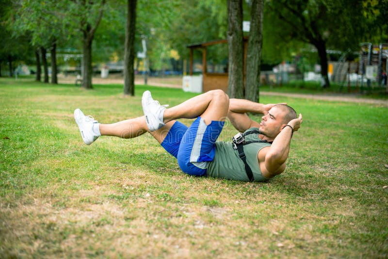 Muscular Build Man Doing Pull-ups in Park Stock Photo - Image of ...