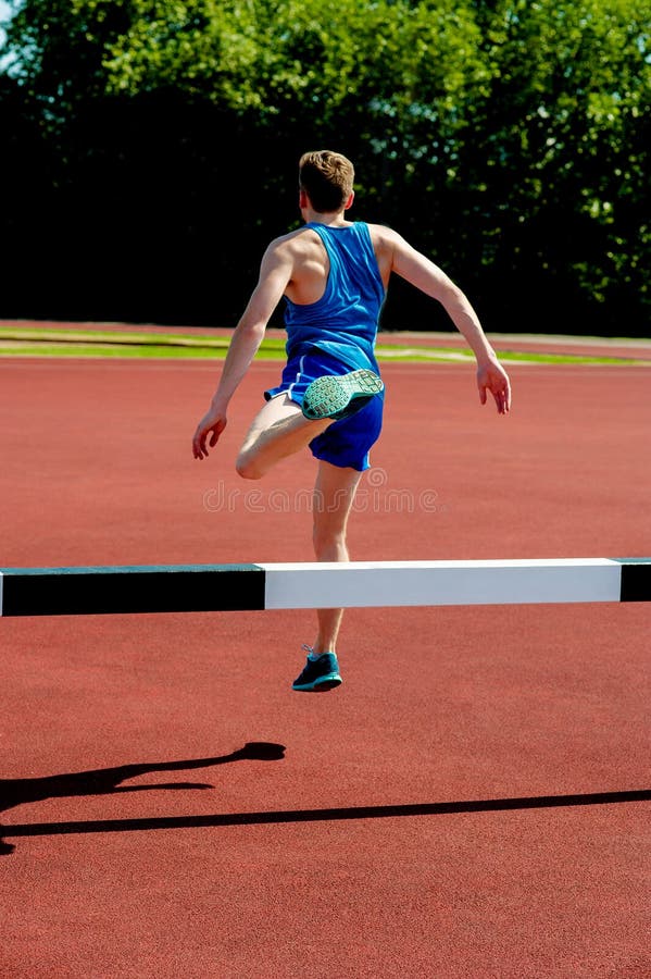 Athlete Jumping Over the Hurdle Stock Photo - Image of athlete, contest ...