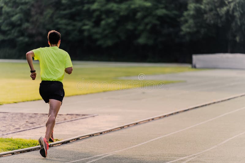 Athlete Making Big Strides while Running on the Athletics Track. Copy ...