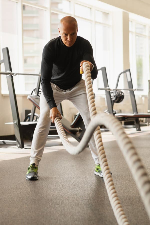 Athlete Man Make Battle Ropes Exercise at Gym. Stock Image - Image of ...