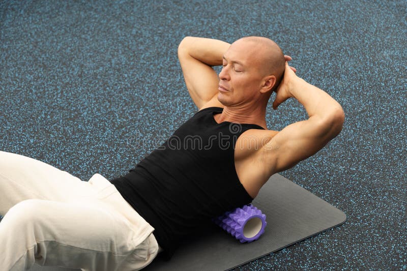 Athlete Man Stretches Using Foam Roller. Close Up. Stock Photo - Image ...
