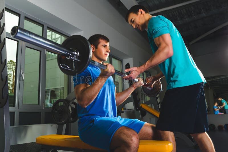 Athlete Muscular Bodybuilder and Personal Trainer in the Gym Training ...