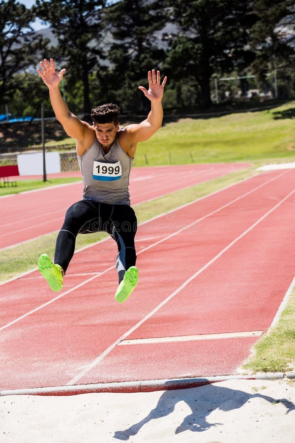 Athlete Performing a Long Jump Stock Image - Image of number, hispanic ...