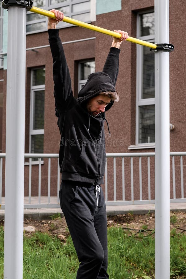 Athlete Performs an Exercise on the Crossbar Stock Image - Image of ...