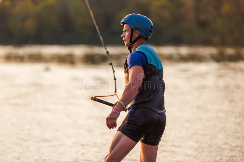 An Athlete Performs a Trick on the Water. Park at Sunset Stock Photo ...