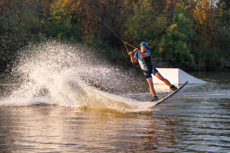 An Athlete Performs a Trick on the Water. Park at Sunset Stock Photo ...