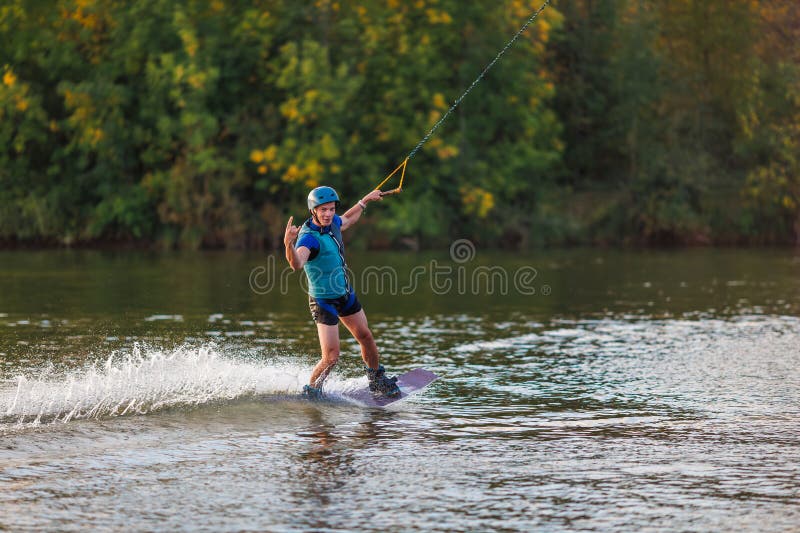 An Athlete Performs a Trick on the Water. Park at Sunset Stock Photo ...