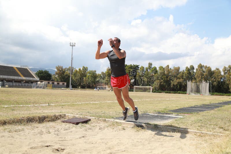Athlete Practicing Long Jump in the Empy Stadium Stock Photo - Image of ...