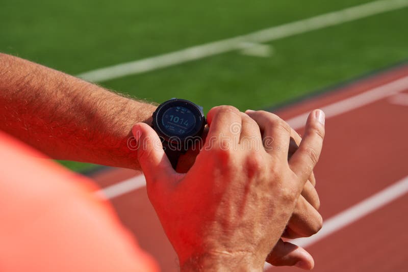 Athlete Prepares for Running Training and Start Using Smart Watch and ...