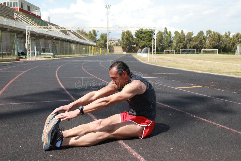 Athlete on a Racing Track Stretching after the Run Stock Image - Image ...