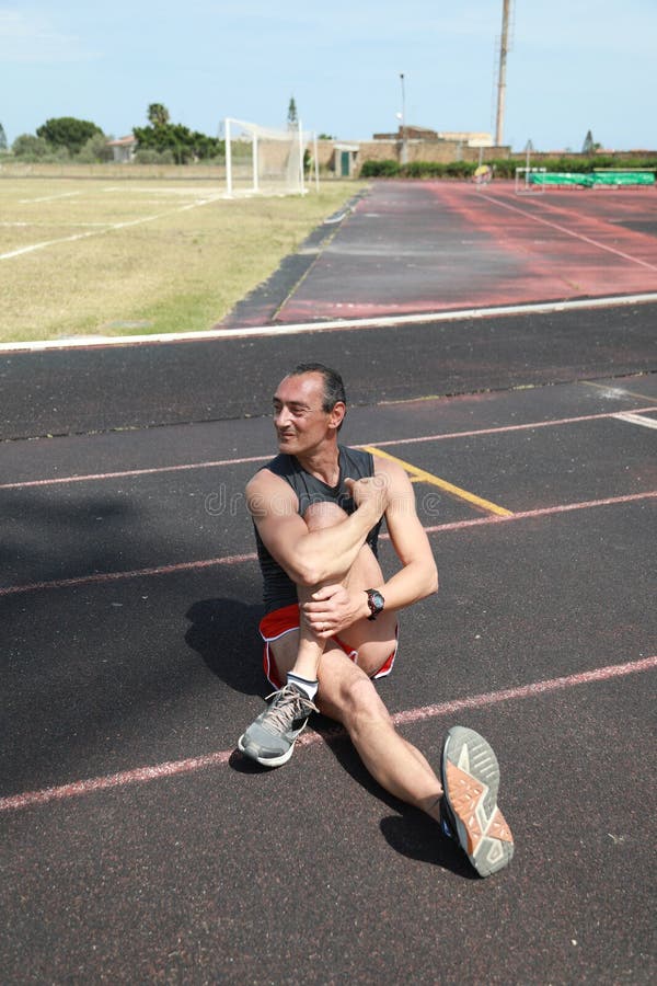 Athlete on a Racing Track Stretching after the Run Stock Photo - Image ...