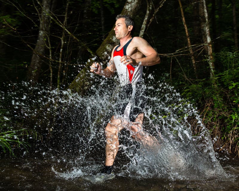 An Athlete is Running through a Streambed Stock Photo - Image of jump ...