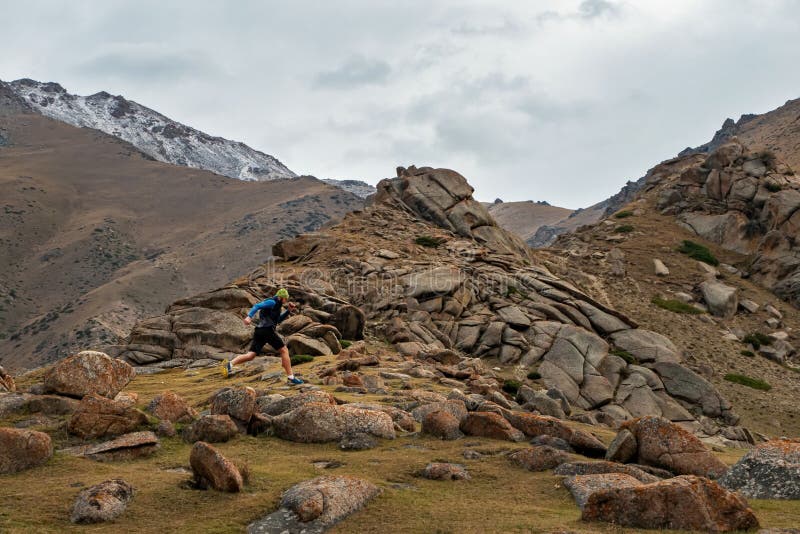 Athlete Runs High in the Mountains among the Rocks Stock Image - Image ...