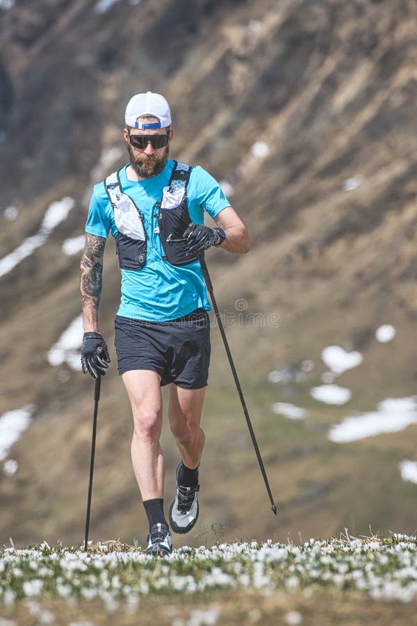 An Athlete Runs with Sticks Stock Image - Image of spring, mountains ...