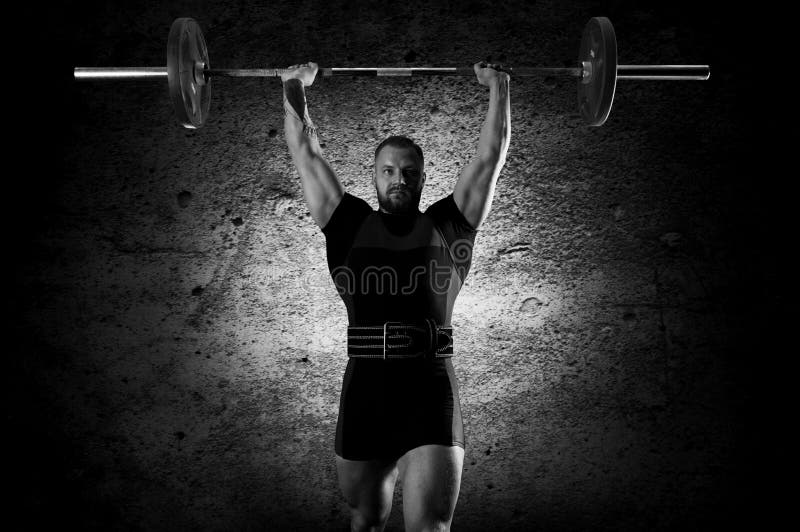 The Athlete is Standing with a Barbell Above His Head. Stock Photo ...