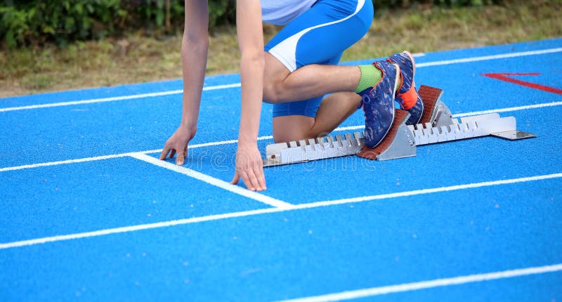 Athlete in the Starting Blocks of a Athletic Track before the St Stock ...