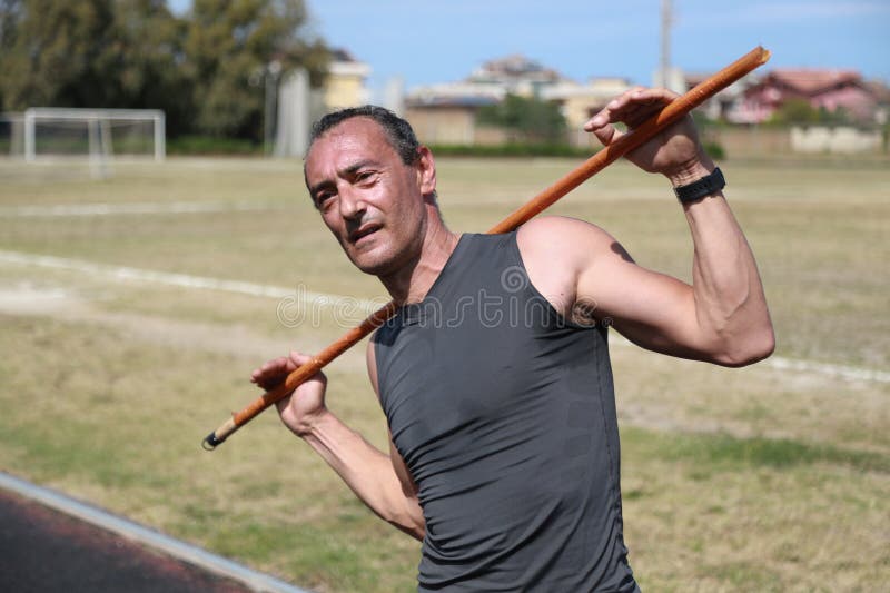 Athlete Using a Bar To Stretch Stock Image - Image of adult, track ...