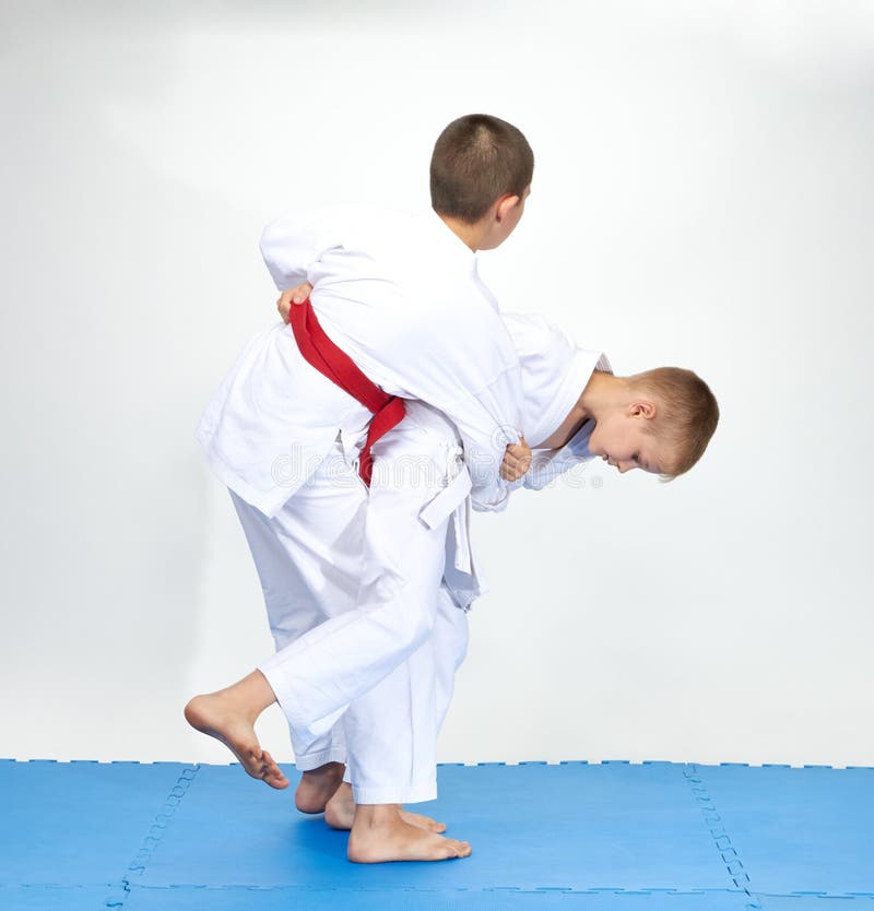 A Boy with a Blue Belt and a Cap of Santa Claus Hits a Kick Leg Stock ...