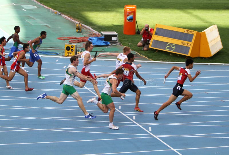 Athletes on the 4 X 100 Meters Relay Race Editorial Stock Image - Image ...