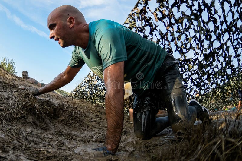 Competitor Crawling through Mud in Obstacle Course Editorial Stock ...