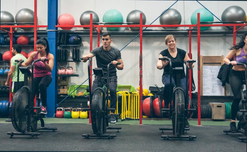 Athletes Doing Air Bike Indoor Stock Photo - Image of riding, activity ...