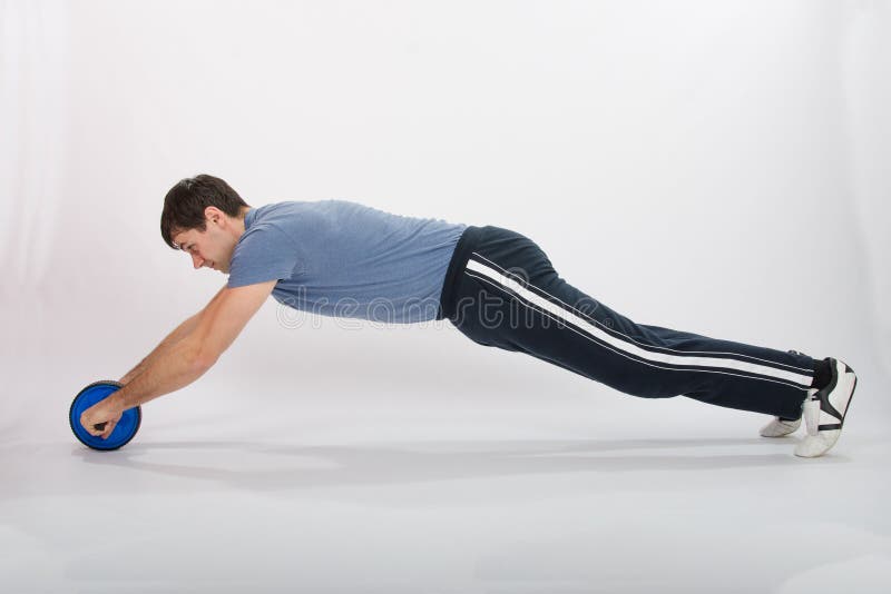 Athletes Perform Push-ups Using the Wheel Stock Image - Image of pants ...