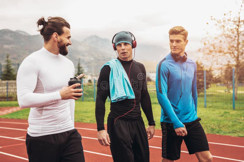 Athletes Practicing a Run on Athletics Stadium Track. Stock Photo ...