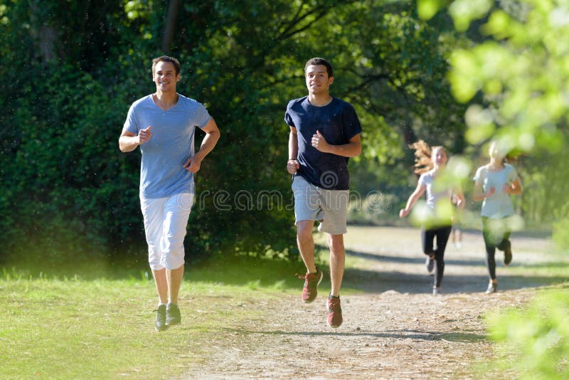 Athletes Running through Forest Stock Image - Image of runner, motion ...