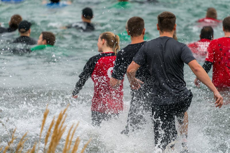 Athletes Running into a Lake Editorial Image - Image of water ...