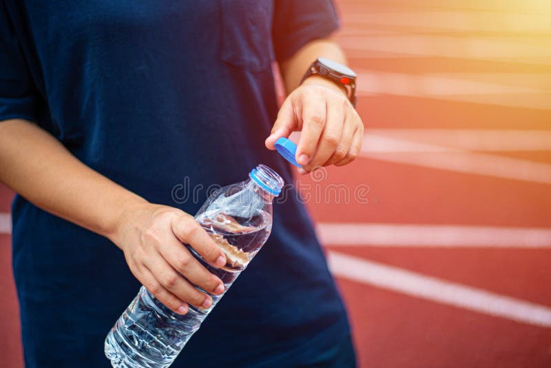 Athletes are in Running Track and Use the Hand To Open the Water Bottle ...