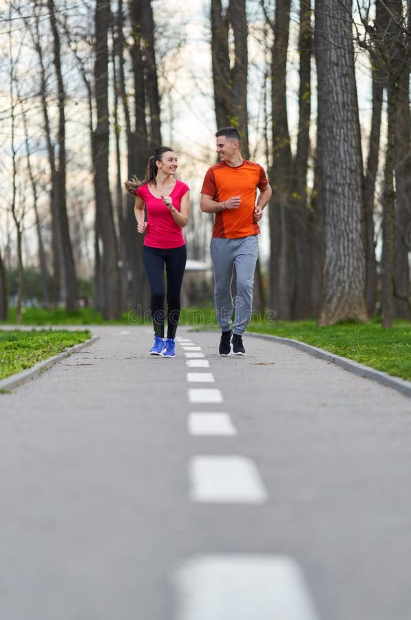 Young Couple Running in the Park Stock Photo - Image of green, exercise ...
