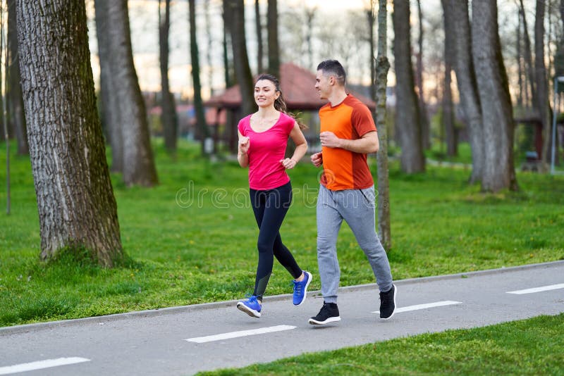 Young Couple Running in the Park Stock Image - Image of adult, running ...