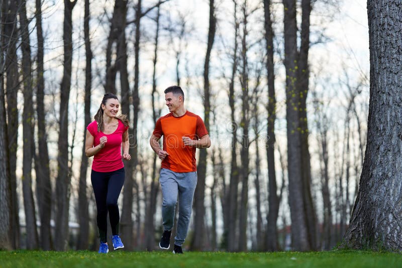 Young Couple Running in the Park Stock Photo - Image of friends, forest ...