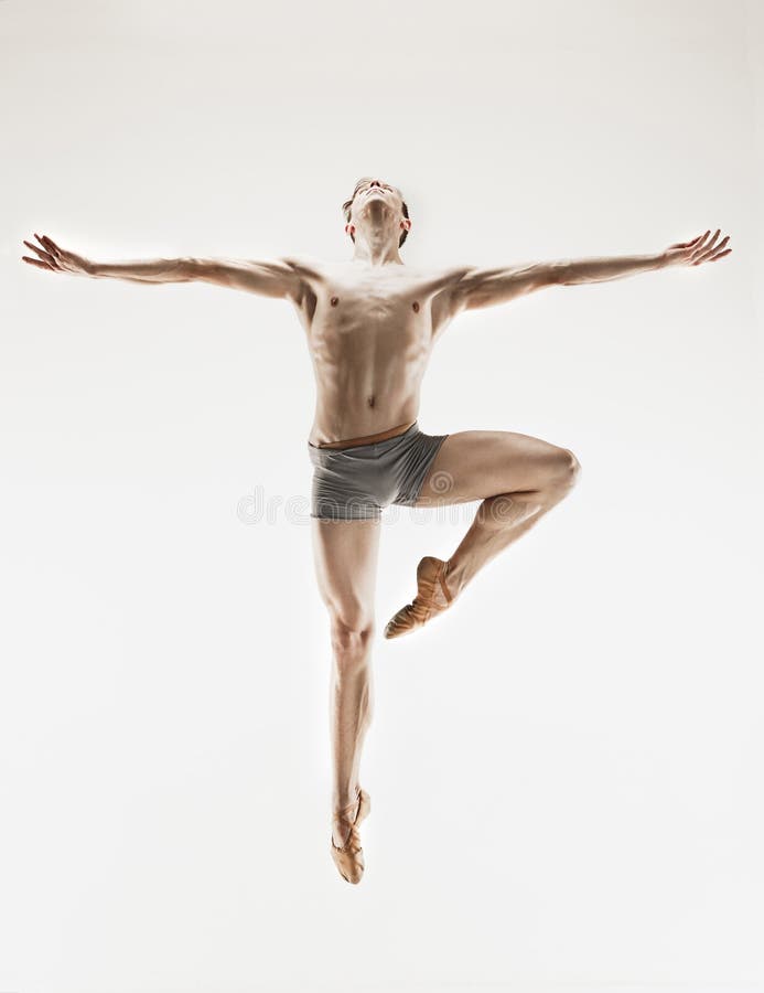 Athletic Ballet Dancer in a Perfect Shape Performing Over the Grey ...