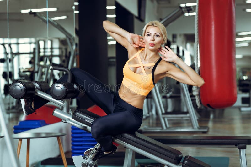 Athletic Blonde Woman Using Press Machine in Gym Stock Photo - Image of ...