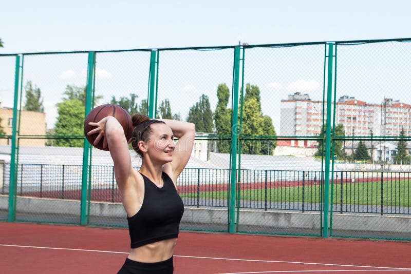 Female Basketball Player Throwing a Ball Up To the Net Stock Photo ...