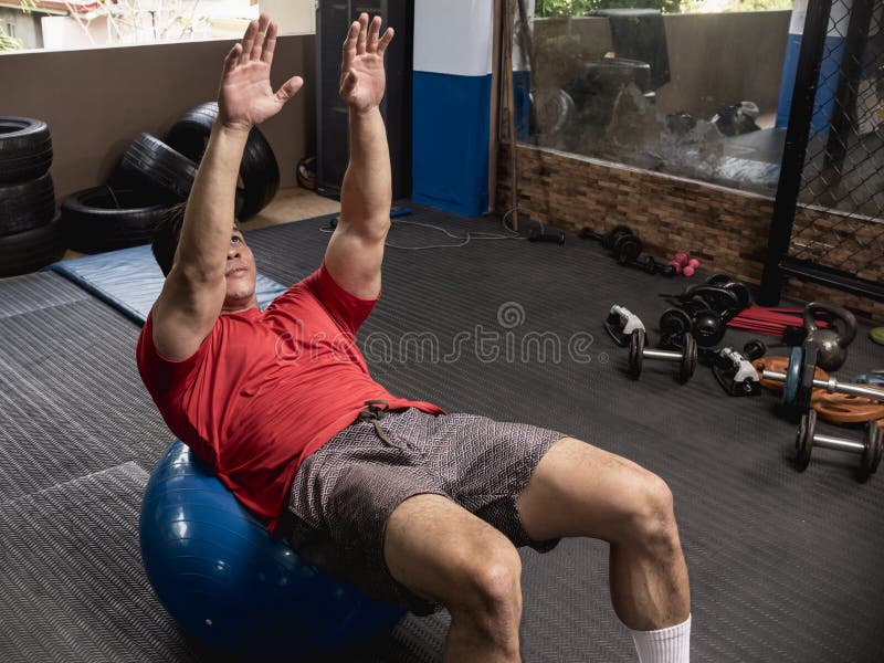 An Athletic and Fit Man Does Abdominal Crunches on a Stability Balance ...