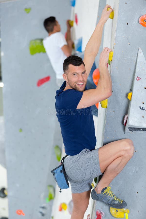 Athletic Male Climbing on Indoor Climbing Wall Stock Photo - Image of ...